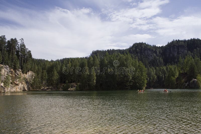 Boulder and Trees Behind a Lake Stock Image - Image of scenics ...