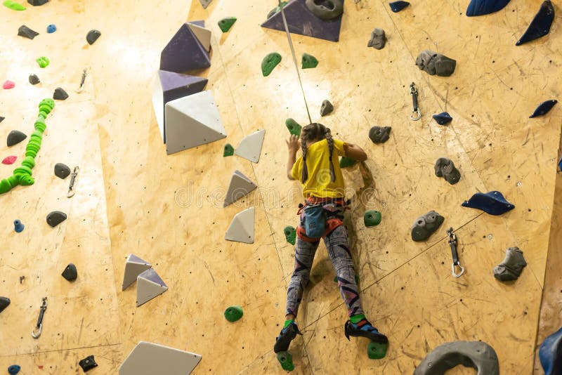 Bouldering, Little Girl Climbing Up the Wall Stock Photo - Image of ...