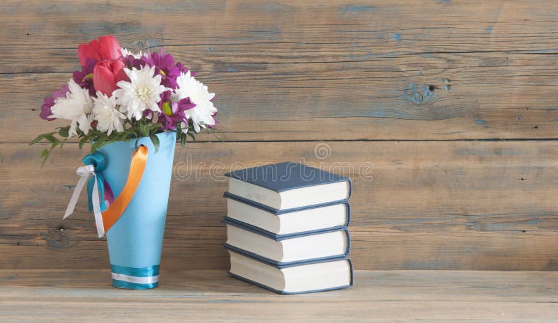 Beautiful Fresh Spring Flowers with Stack of Books on a Table Stock ...