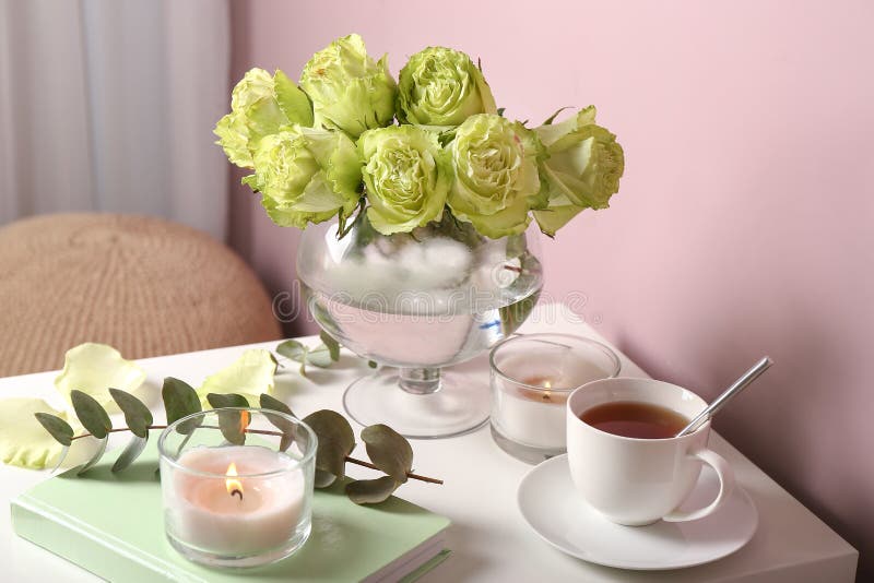 Bouquet of Beautiful Green Roses, Candle and Cup of Tea on Table Stock ...