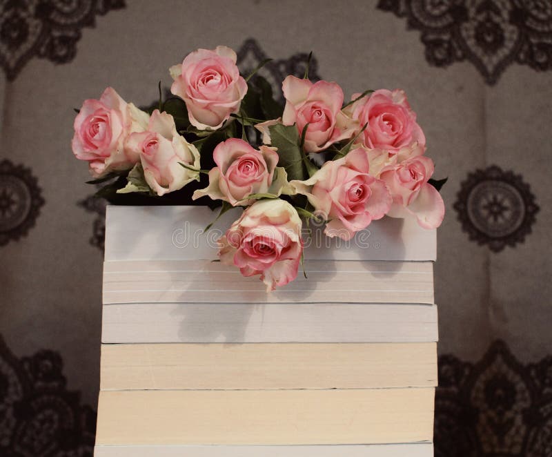 Bouquet of Beautiful Pink Roses on a Stack of Books Stock Photo - Image ...