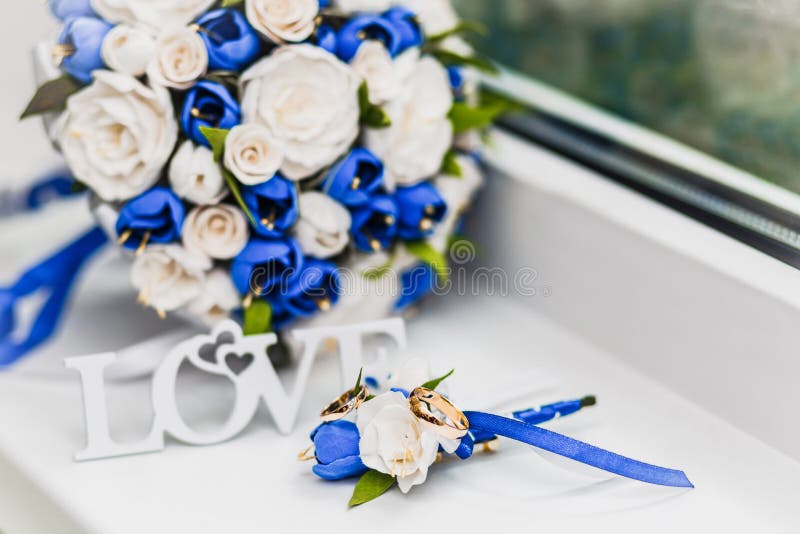 A Bouquet of the Bride from White and Blue Roses and Wedding Rings from ...