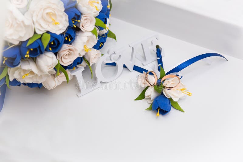 A Bouquet of the Bride from White and Blue Roses and Wedding Rings from ...