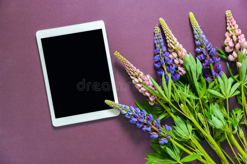 Bouquet of Flowers on a Purple Background with a Tablet Computer Stock ...