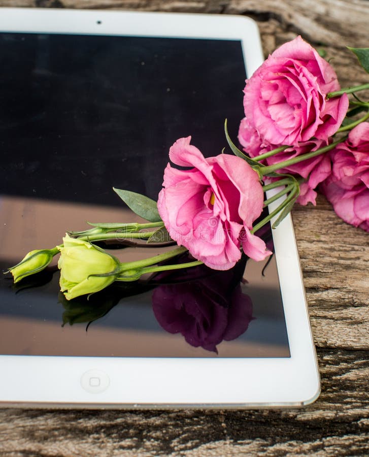 Bouquet of Flowers on a Wooden Table with a Tablet Computer Wit Stock ...