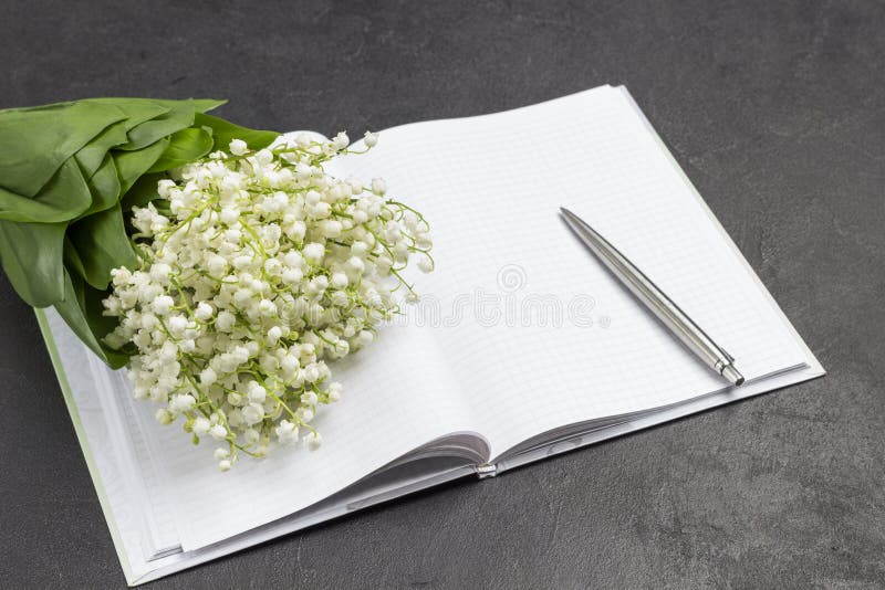 Bouquet of Lilies of the Valley on Open Notebook Page Stock Photo ...