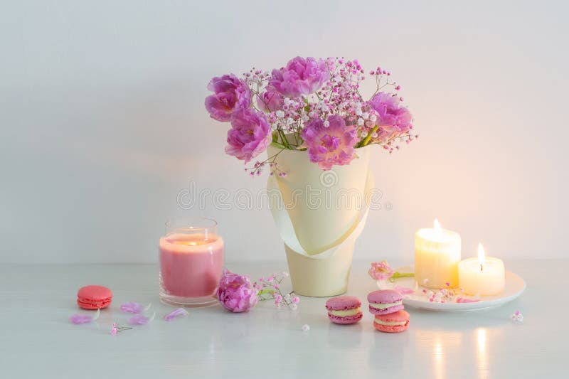 Bouquet of Pink Spring Flowers and Burning Candles on White Table Stock ...