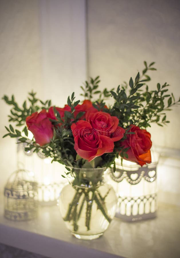 A Bouquet of Red Roses and Boxwood in a Vase Stock Photo - Image of ...