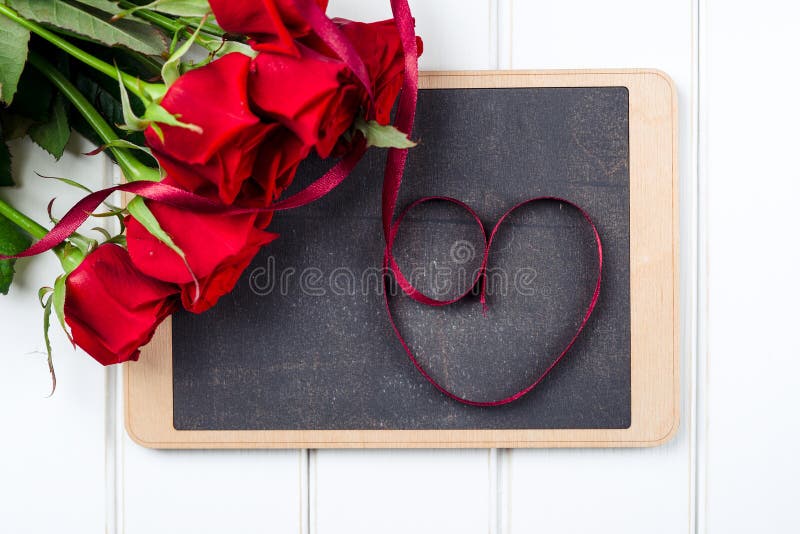 Bouquet of Red Roses and Chalkboard on White Wooden Board. Space for ...