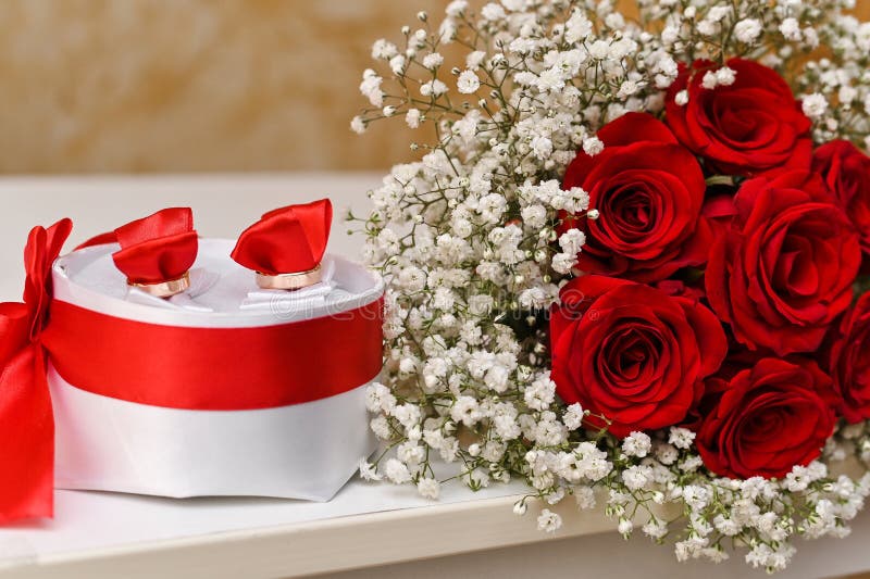 A Bouquet of Red Roses and a Gift in a Box with Red Ribbons on the ...