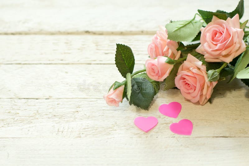 Bouquet of Small Pink Roses Lying on White Textured Table with Hearts ...