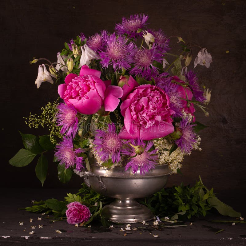 Bouquet of Spring Flowers in a Pewter Vase on a Dark Background Stock ...