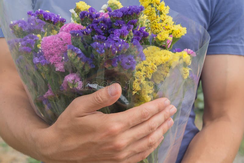 Bouquet of Violet, Yellow, Pink and White Statis in the Man`s Hands ...