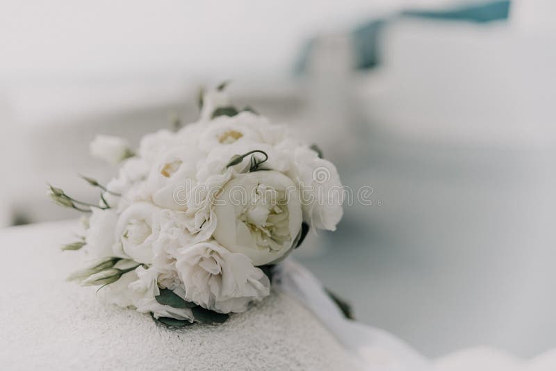 A Bouquet of White Flowers is Sitting on a White Surface. the Flowers ...