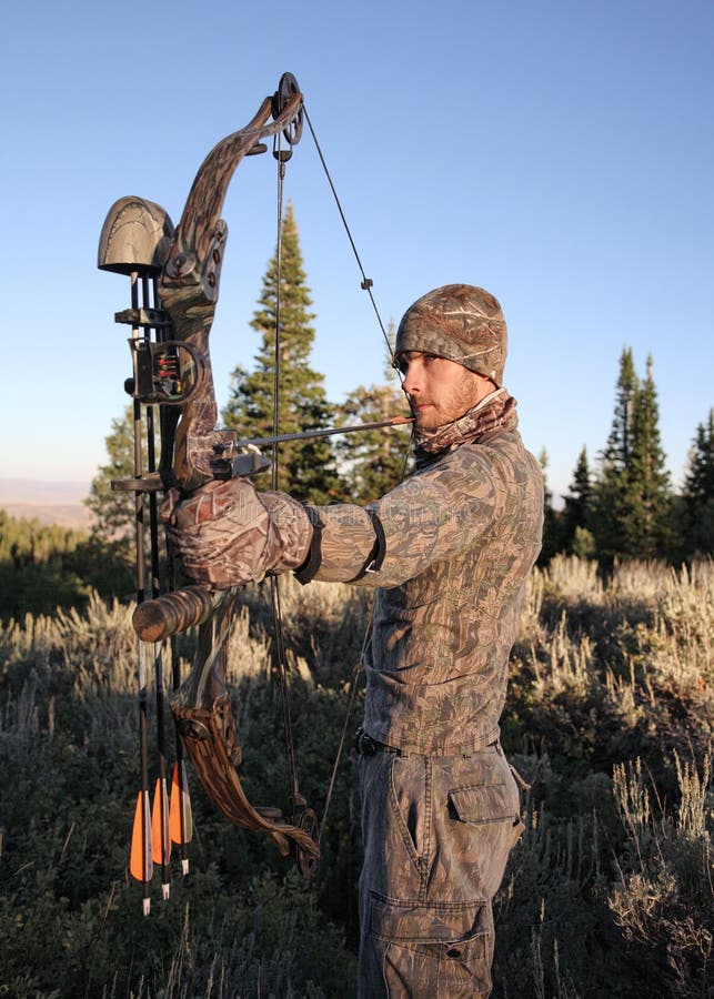 Bow Hunter Drawing Compound Bow in Mountains Stock Image - Image of ...