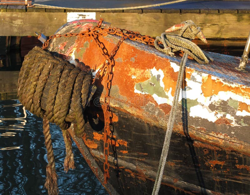 The Bow of an Old Rusty Iron Canal Boat Moored with Ropes on a Jetty ...