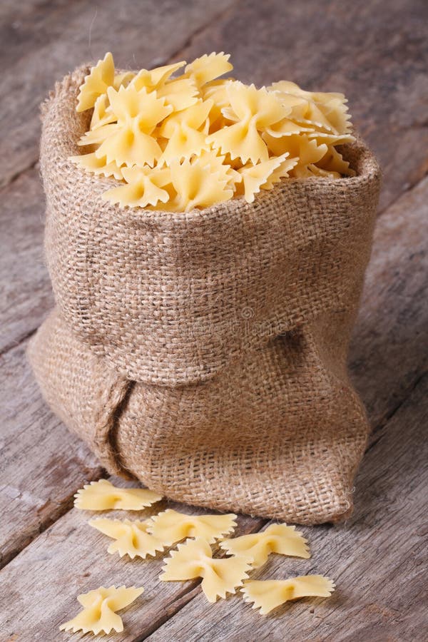 Bow Tie Pasta Dry in Sackcloth Bag on the Old Table Closeup Stock Photo ...