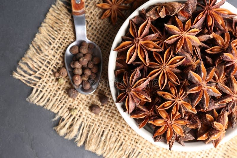 Bowl with Aromatic Anise Stars and Pepper on Dark Table, Flat Lay Stock ...