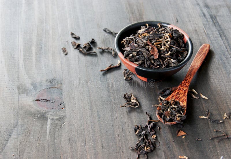 Bowl with Black Tea and Spoon on a Wooden Stock Photo - Image of ...