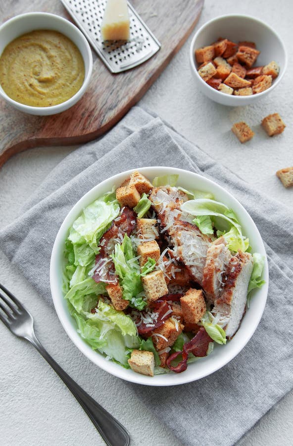 A bowl of Caesar salad stock photo. Image of cookery - 330594144