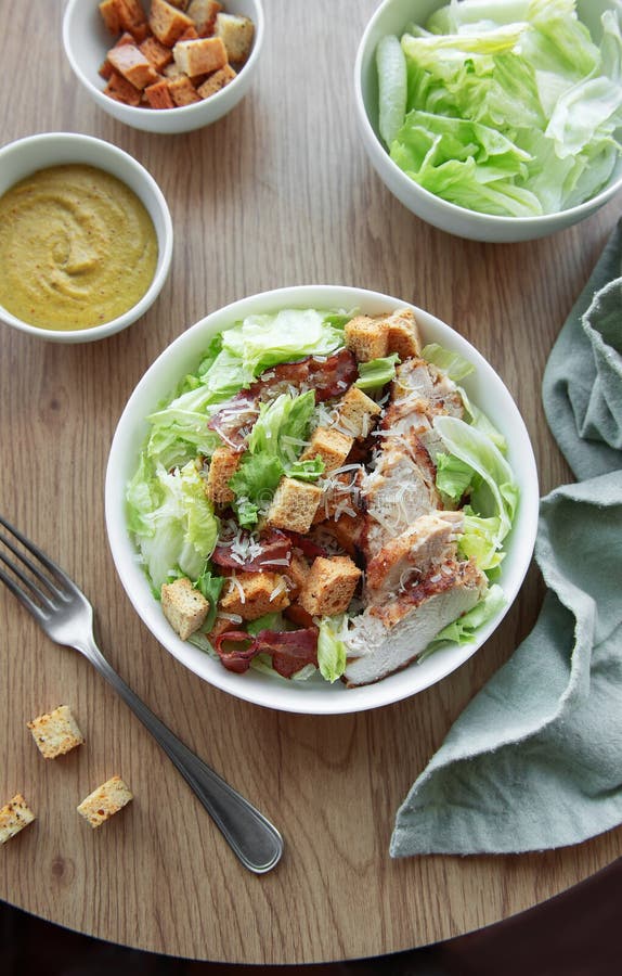 A bowl of Caesar salad stock photo. Image of cookery - 330940476