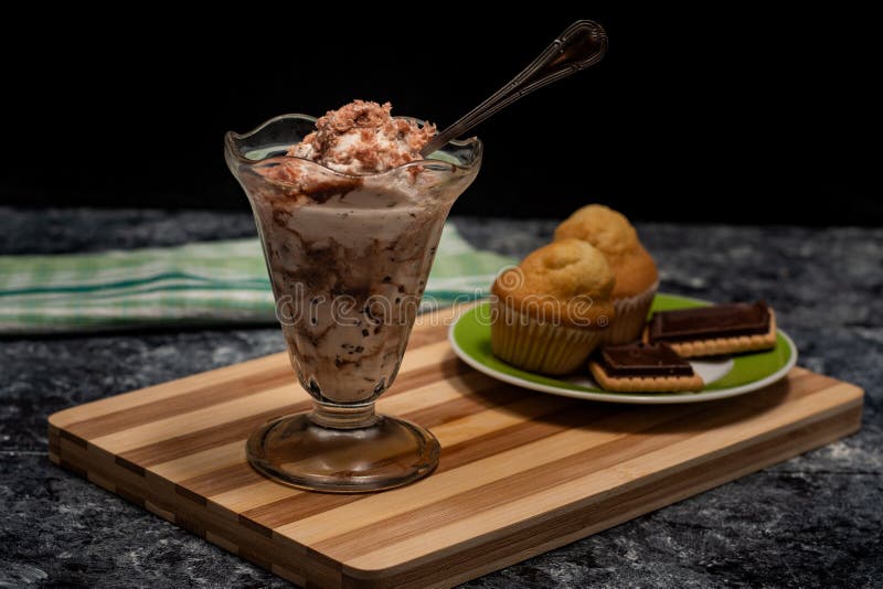 Bowl of Chocolate Ice Cream with a Plate of Pastries Stock Photo ...