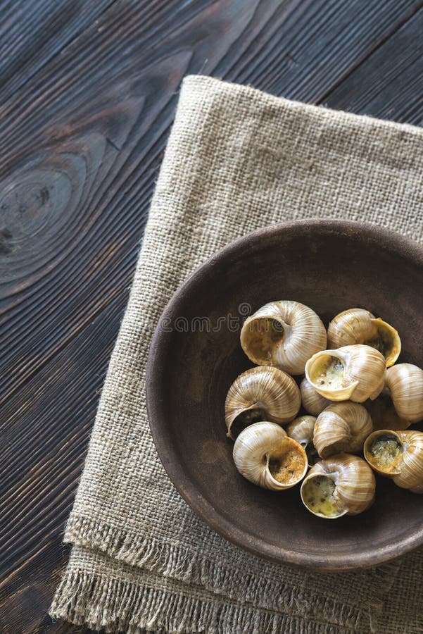 Bowl of cooked snails stock photo. Image of garlic, cooked - 99908882