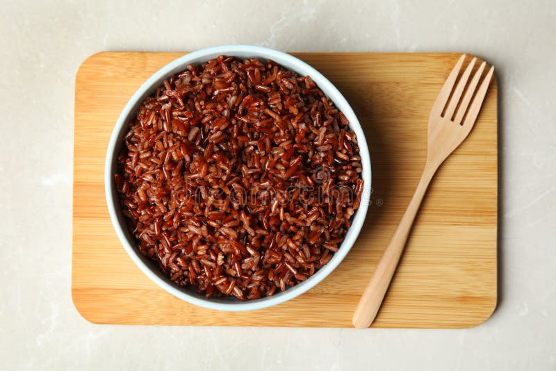 Bowl with Delicious Cooked Brown Rice on White Marble Table Stock Image ...