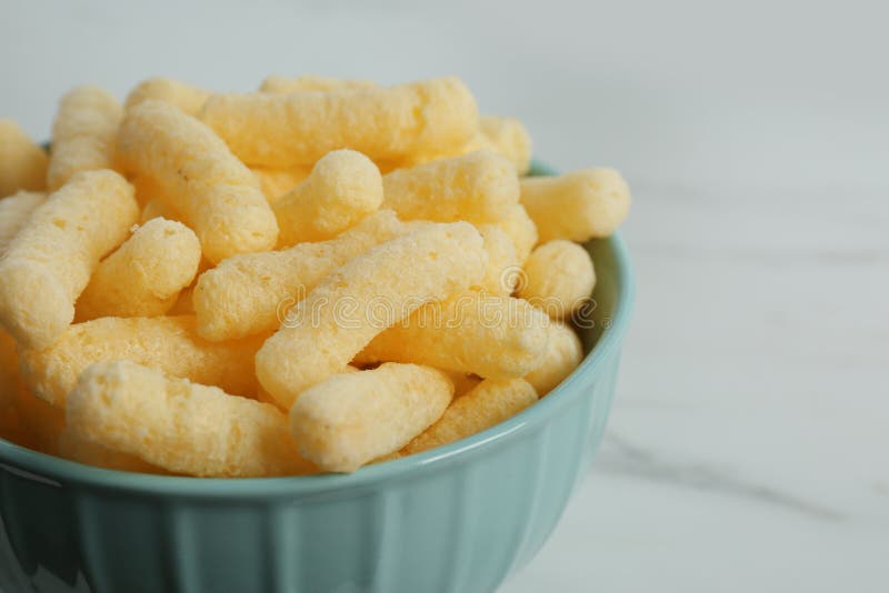 Bowl of Delicious Crispy Corn Sticks on White Marble Table, Closeup ...