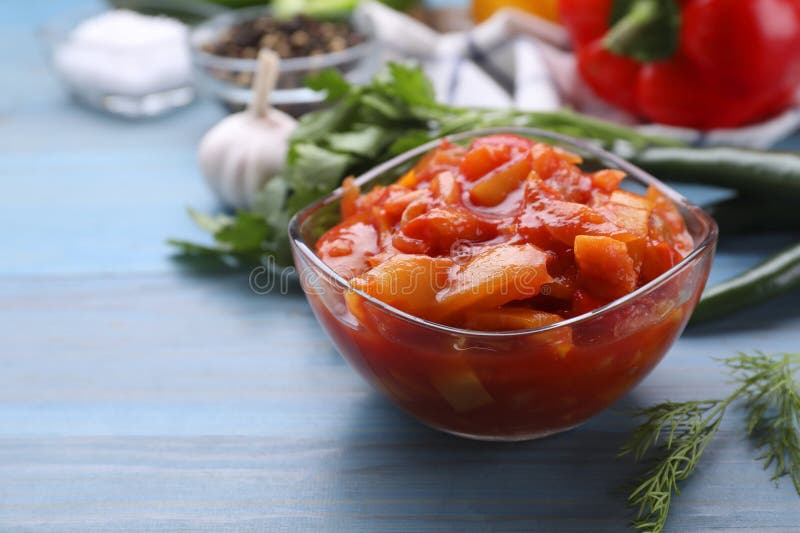 Bowl of Delicious Lecho on Light Blue Wooden Table, Closeup. Space for ...