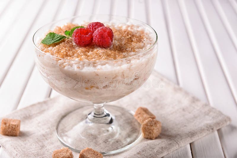 Bowl with Delicious Rice Pudding and Raspberry on White Table Stock ...