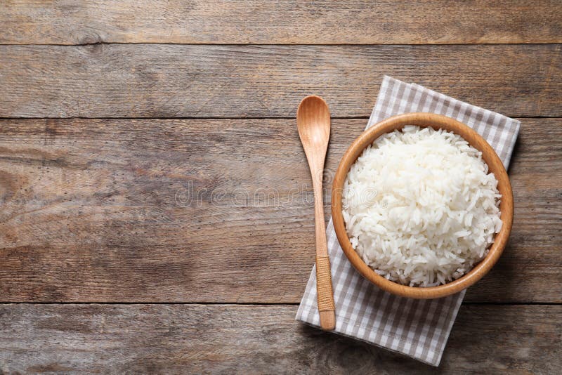 Bowl of Delicious Rice on Wooden Table, Top View Stock Photo - Image of ...