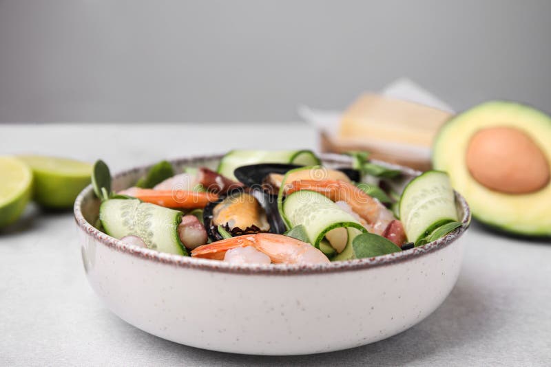 Bowl of Delicious Salad with Seafood on Light Grey Table Stock Image ...