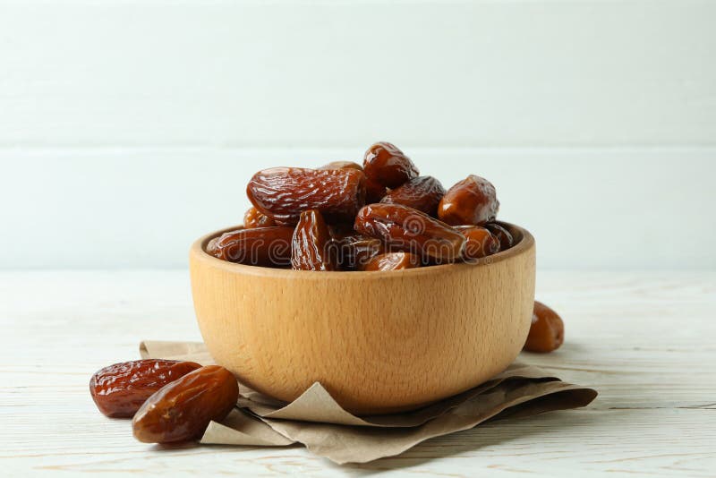 Bowl with Dried Dates on Paper on White Wooden Table Stock Photo ...