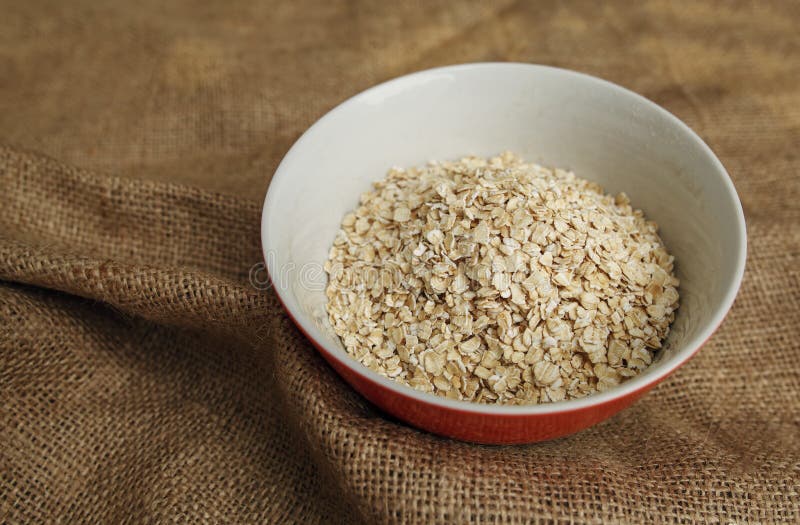 Bowl of Dry Oatmeal on Rustic Textile Stock Image - Image of close ...