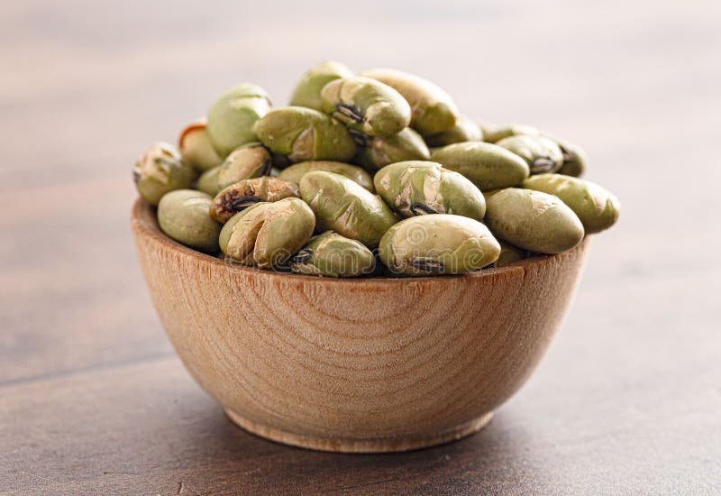 A Bowl of Dry Roasted Edamame Soybeans on a Wooden Table Stock Image ...