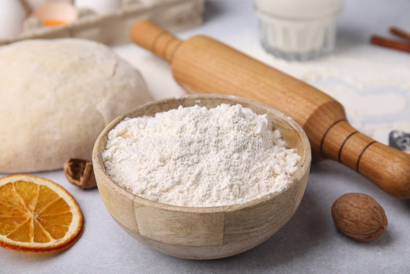 Bowl of Flour, Rolling Pin and Ingredients on White Table Stock Photo ...