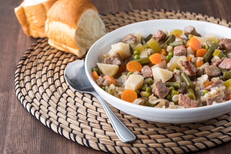 A Bowl of Fresh Homemade Beef Stew Served with Dinner Buns. Stock Image ...