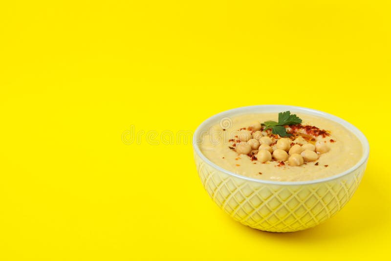 Bowl of Fresh Hummus on Yellow Background Stock Photo - Image of humus ...