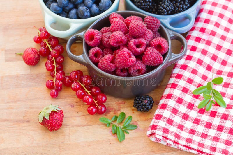 Mix of Fresh Berries with Leaves on Textured Metal Background Stock ...