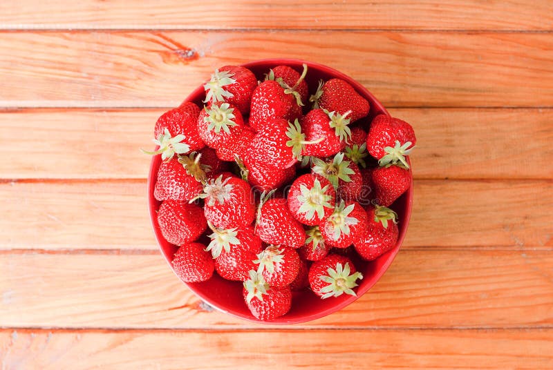 A Bowl Full of Strawberries in the Middle of the Table, Top View Stock ...