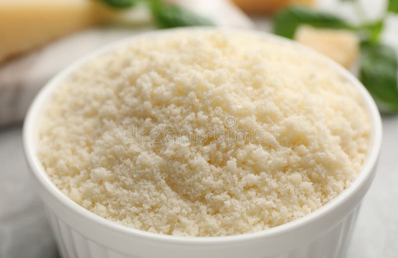Bowl with Grated Parmesan Cheese on Light Table, Closeup Stock Image ...