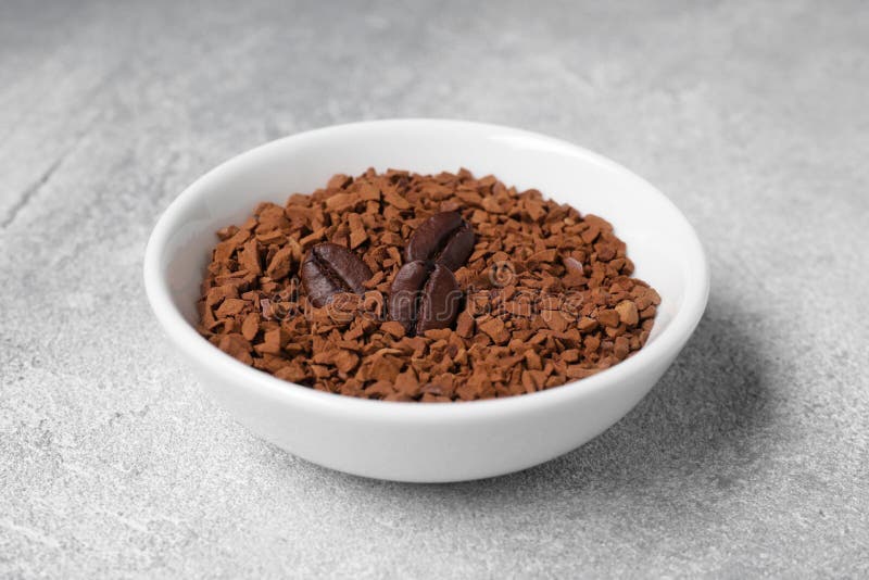 Bowl with Instant Coffee and Roasted Beans on Light Grey Table Stock ...