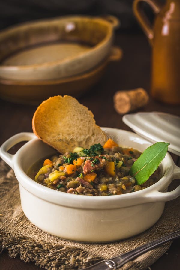 Bowl of Lentil Stew, Toasted Bread and Bay Leaf on Rustic Wooden Table ...