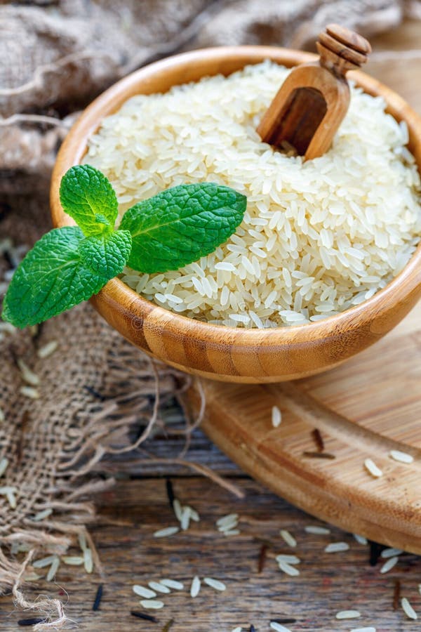 Bowl with Long Grain Rice, Shovel and a Sprig of Mint. Stock Image ...