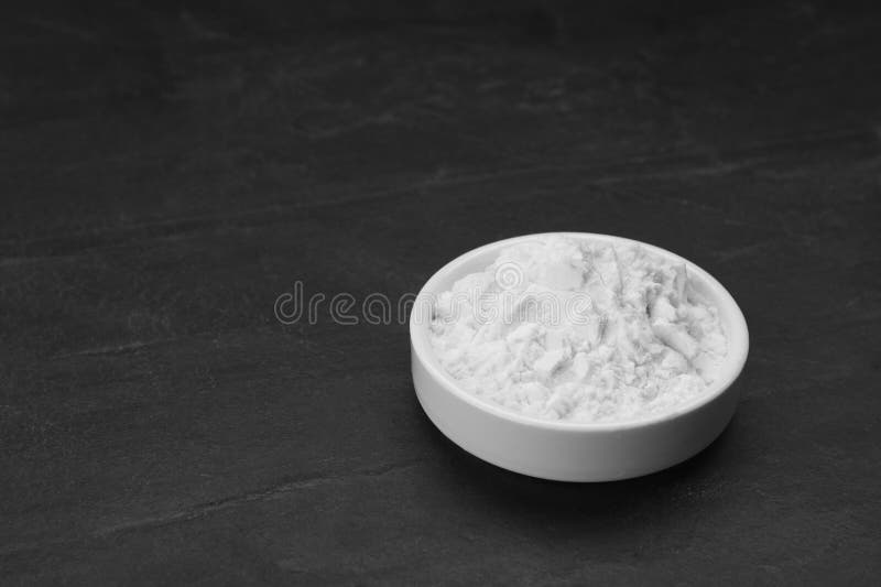 Bowl of Natural Starch on Black Table, Space for Text Stock Photo ...