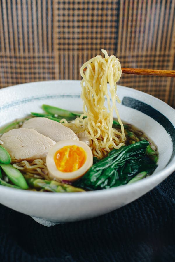 A Bowl of Noodles with a Piece of Chicken and Egg in it Stock Image ...