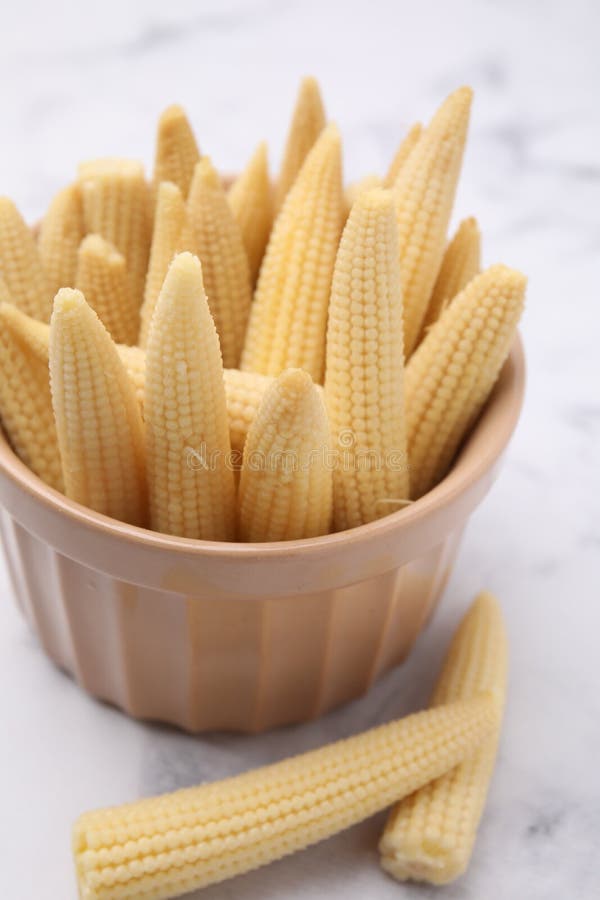 Bowl and Pickled Baby Corn on White Marble Table, Closeup Stock Photo ...