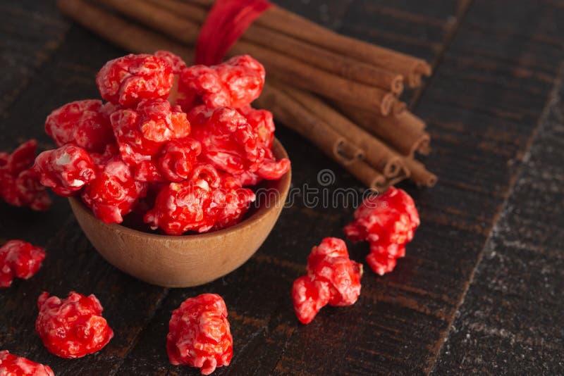 Bowl of Red Cinnamon Popcorn on a Wooden Table Stock Image - Image of ...