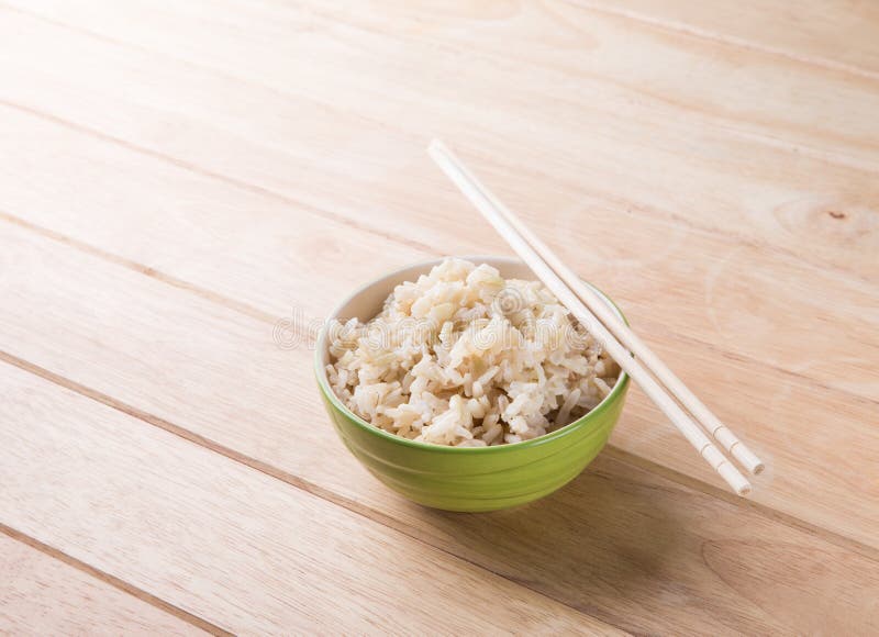 Bowl of Rice with Wooden Chopsticks on the Table. Stock Photo - Image ...